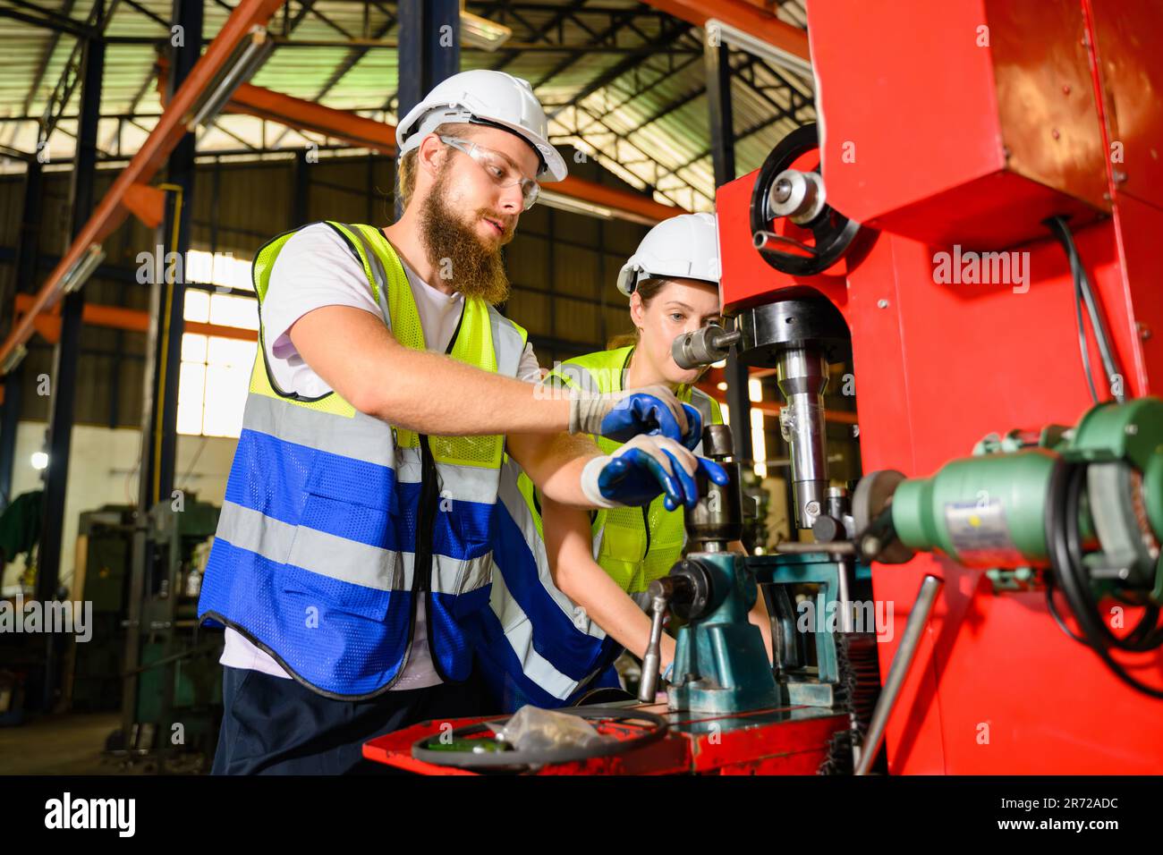 Mechanical engineers repairing engine machine at factory Stock Photo ...