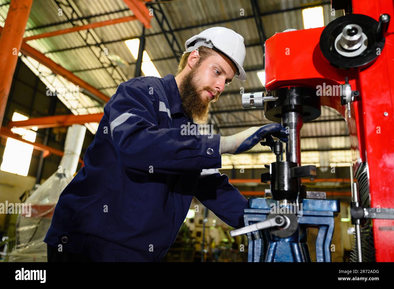 Mechanical engineer repairing engine machine at factory Stock Photo - Alamy