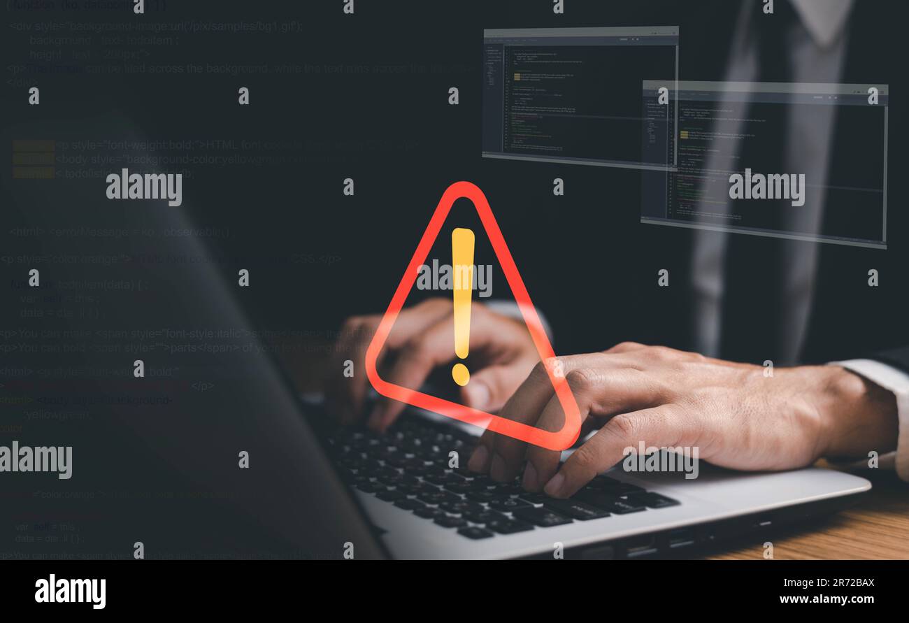Businessman or it staff , programmer, developer using computer laptop with triangle caution ...