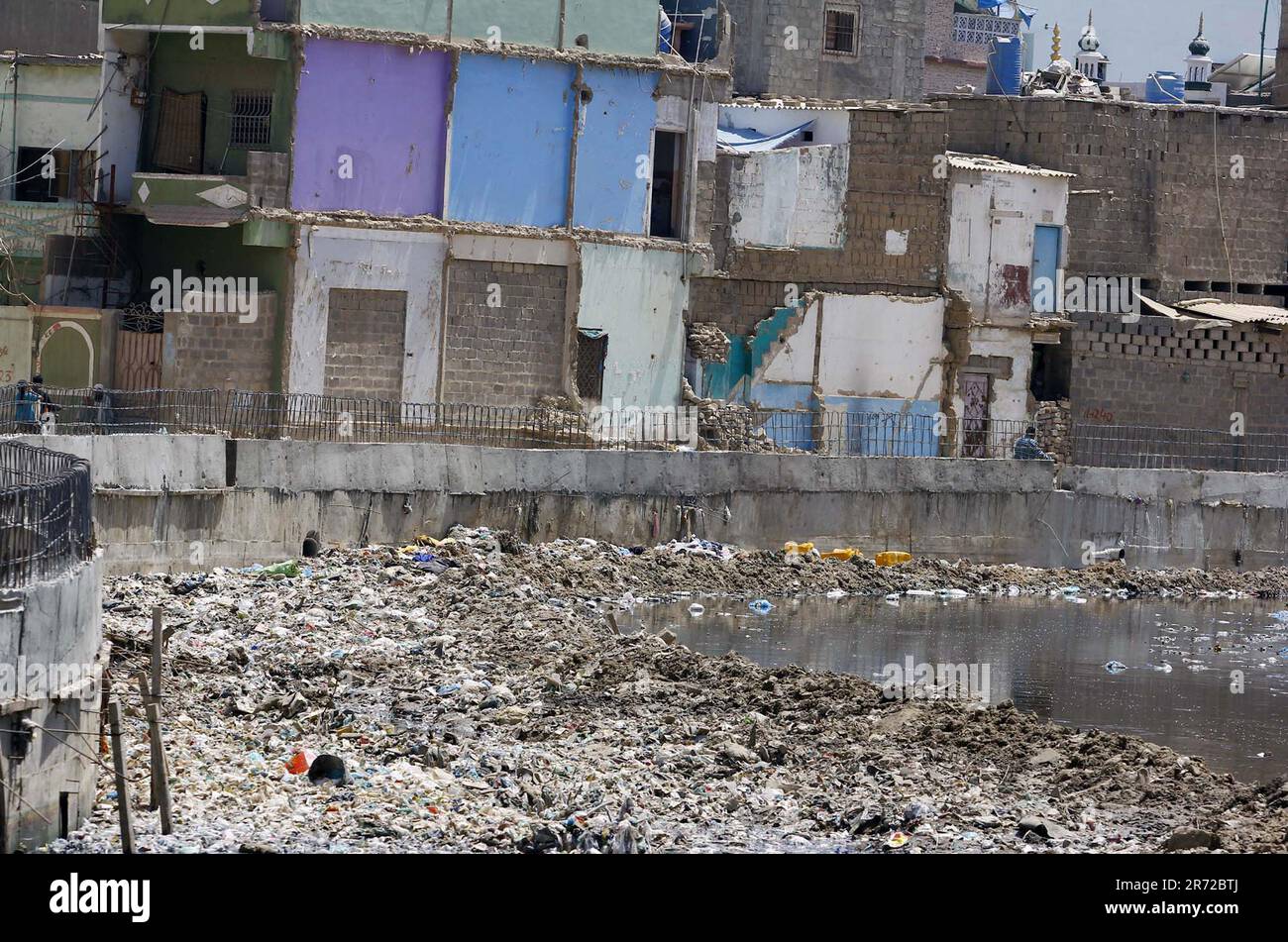 View of open main sewerage drain seen covered with heap of garbage ...
