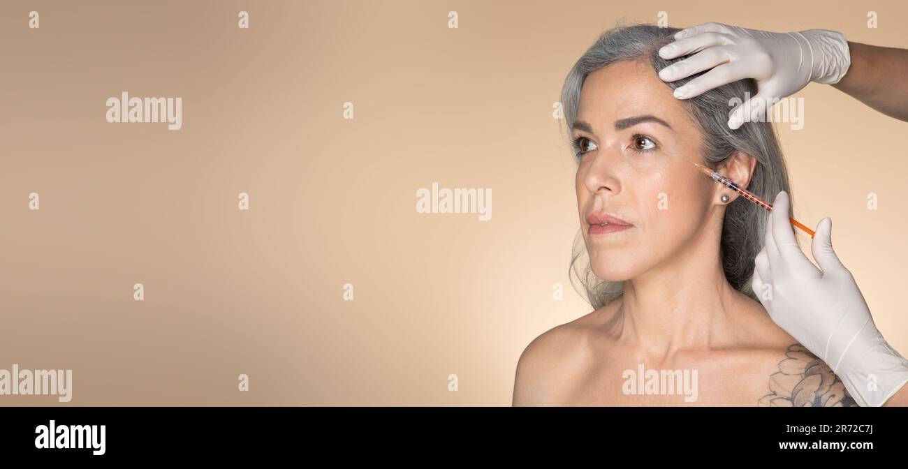 Plastic surgery clinic ad. Good-looking senior woman getting cosmetic ...