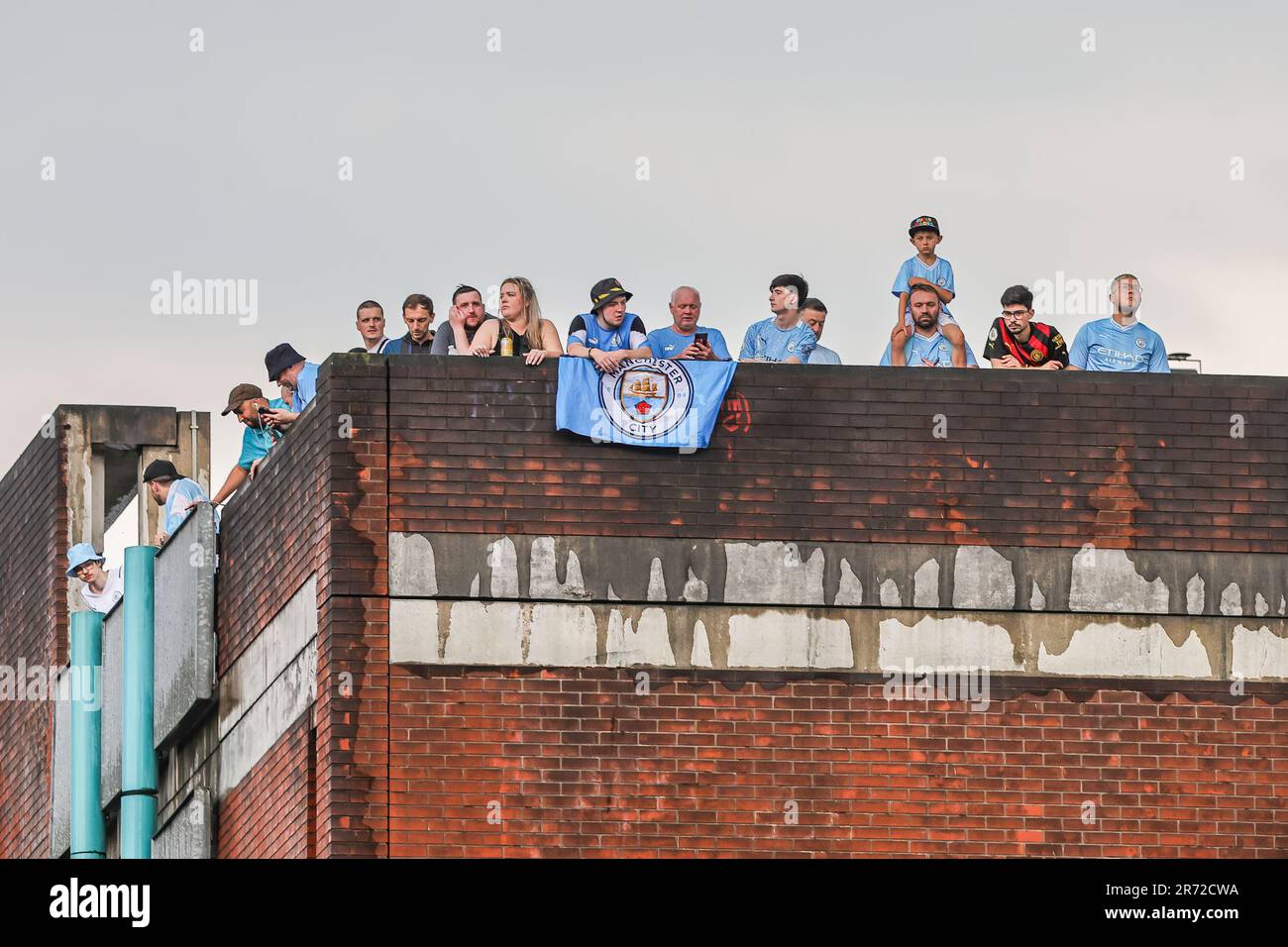 Fans take up roof top vantage point during Manchester City's Treble ...