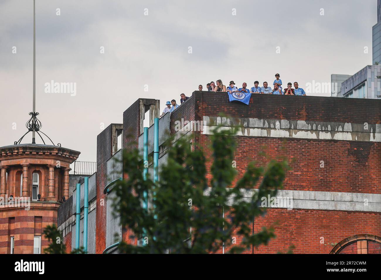 Fans take up roof top vantage point during Manchester City's Treble ...
