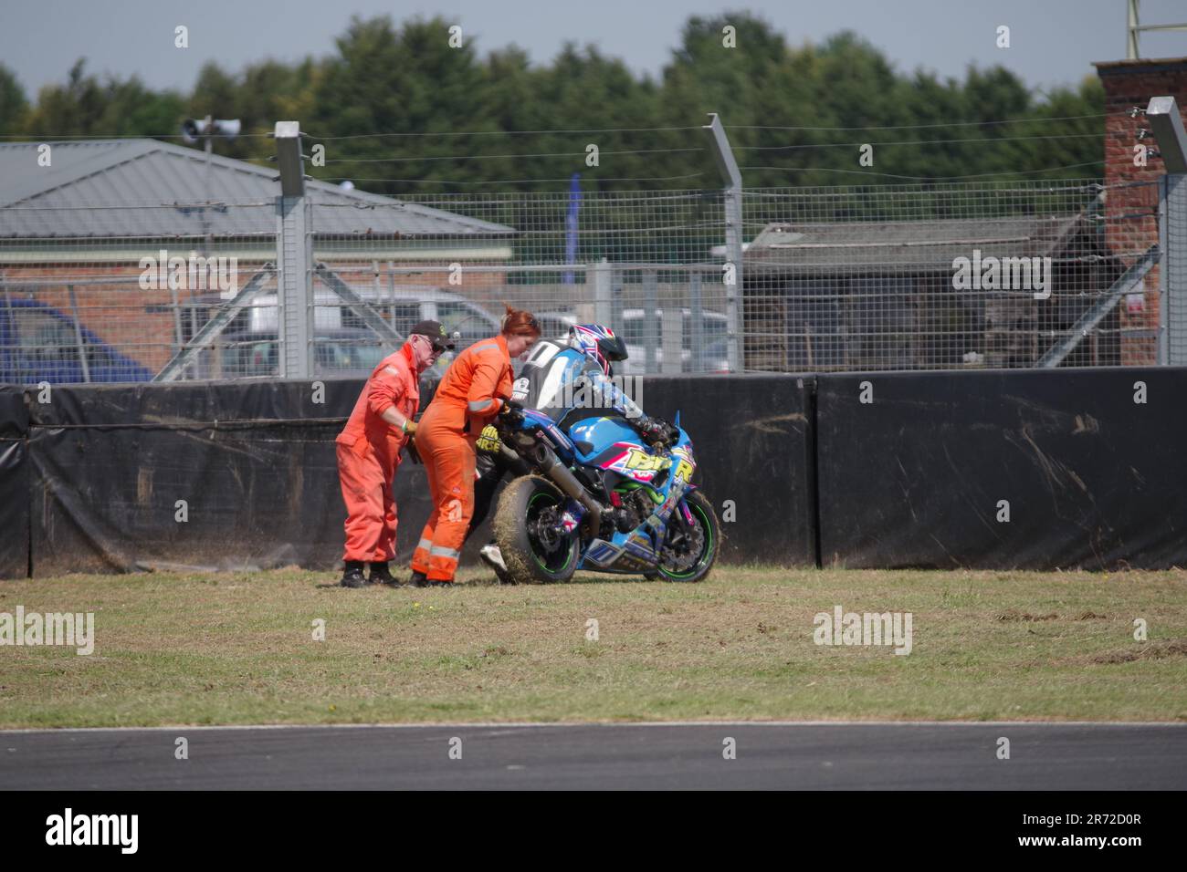 Croft Circuit, 10 June 2023. Marshals assisting Andy Smart and his Kawasaki 600 after breaking ...