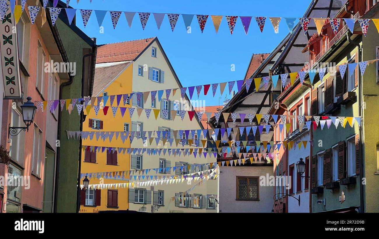 A vibrant scene of colorful array of flags lined along the street Stock ...
