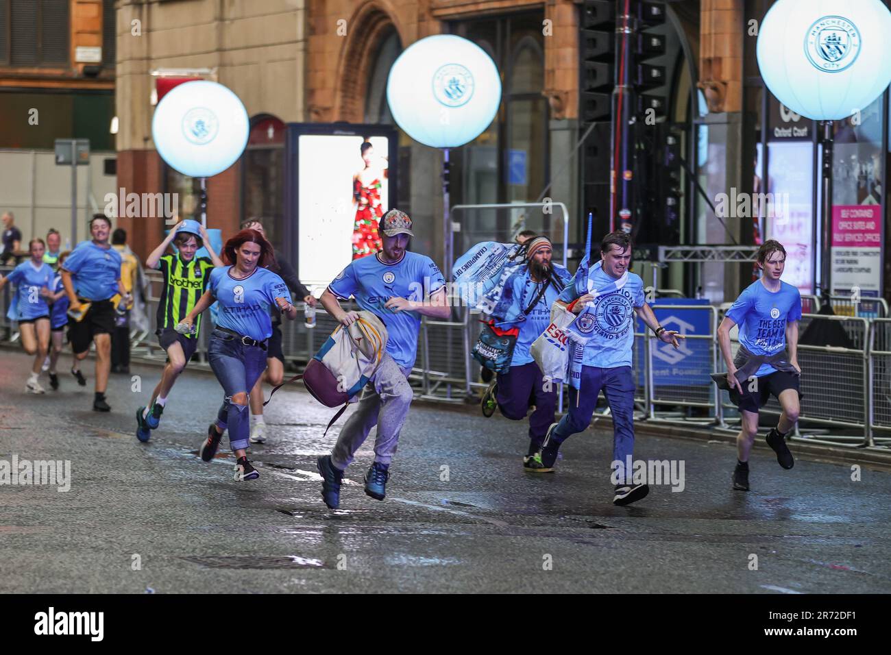 Fans run to the stage as gates are opened ahead of the Manchester City ...
