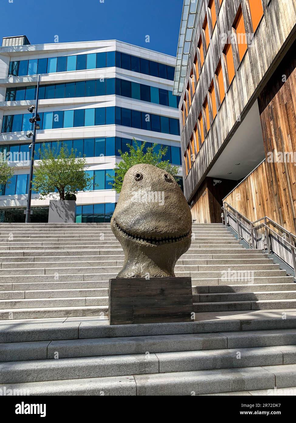A large stone sculpture of a face on the stairs of a grand edifice in ...