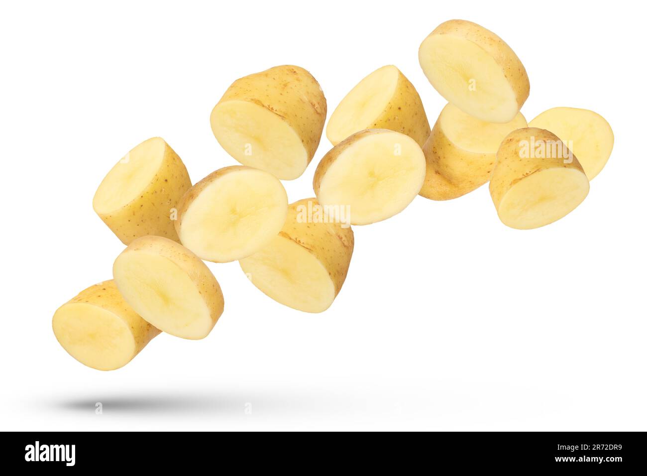 Flying vegetables. Flying potato halves and wedges isolated on white ...