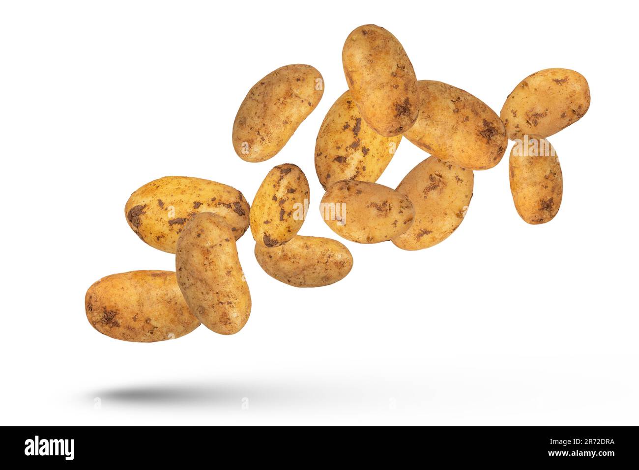 Flying vegetables. Flying potatoes isolated on white background ...