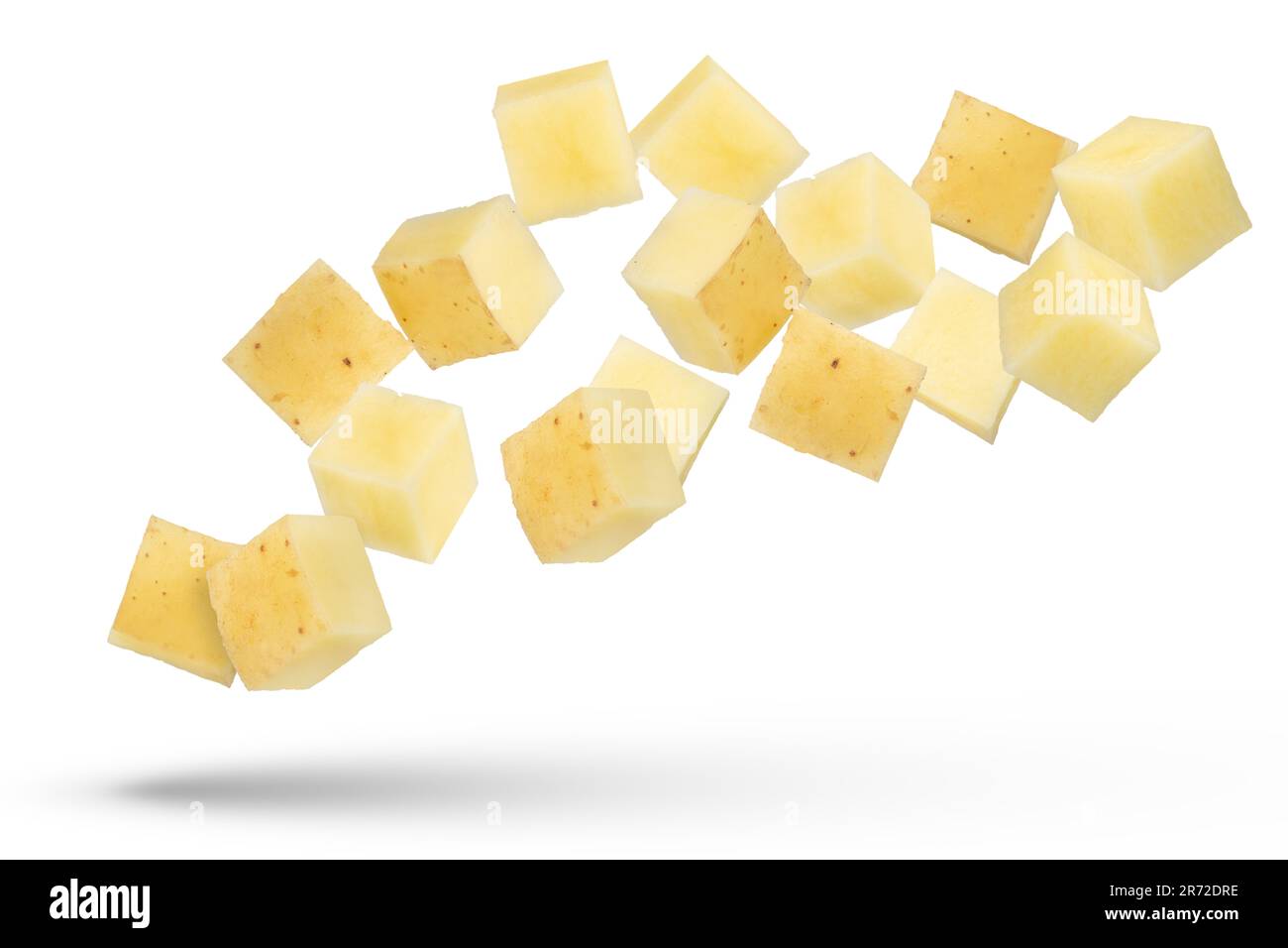Flying vegetables. Flying potato cubes isolated on white background ...