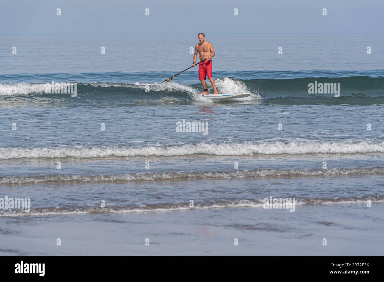 Happy man paddleboarding in hi-res stock photography and images - Alamy