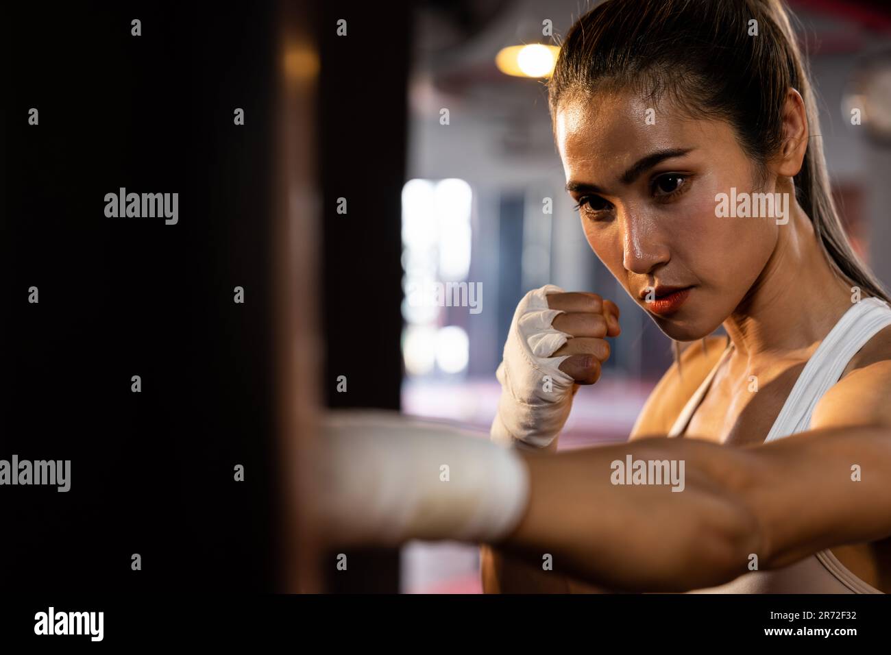 Female boxer kicking punching bag hi-res stock photography and images ...