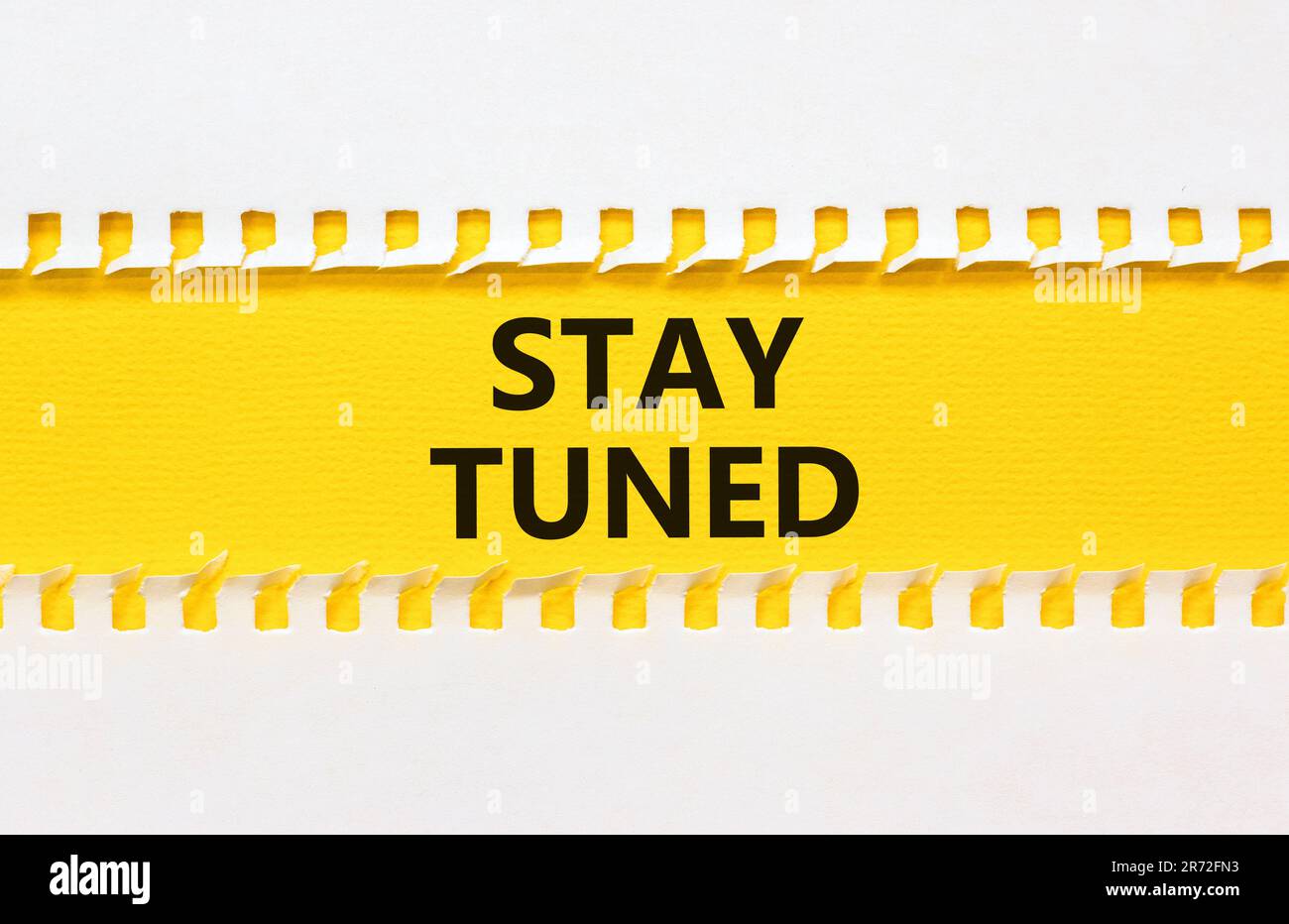 Stay tuned symbol. Concept words Stay tuned on beautiful yellow paper ...