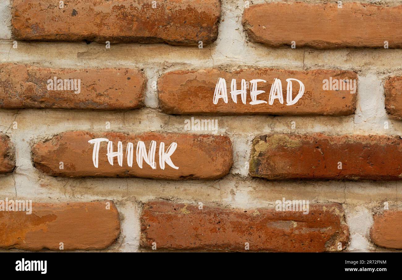 Think ahead symbol. Concept words Think ahead on beautiful brown brick ...