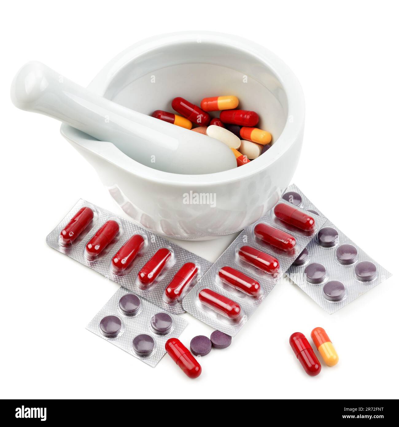 Assortment of medicinal tablets and ceramic mortar with pestle isolated ...