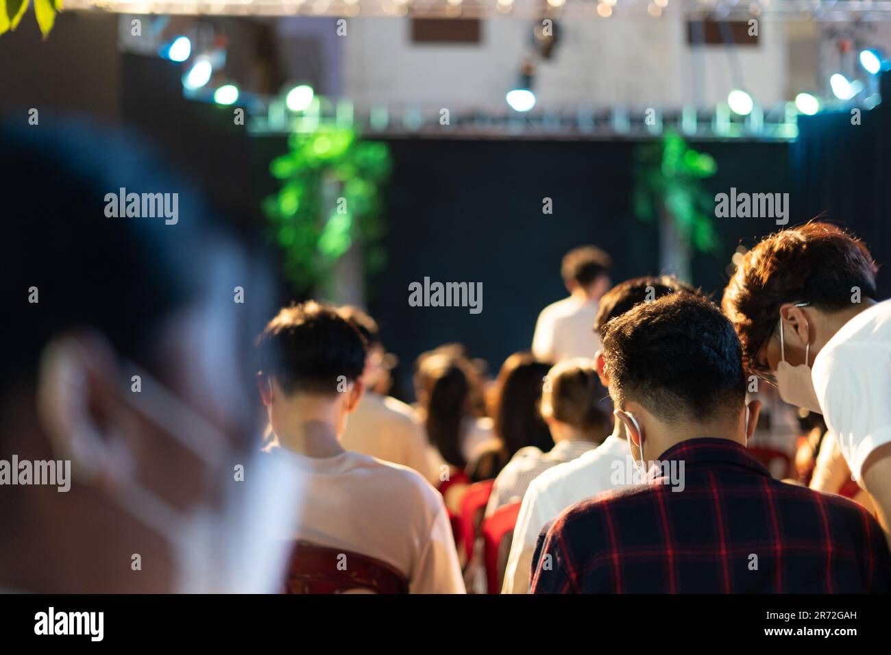 A group of people in awe and anticipation in front of a stage ...