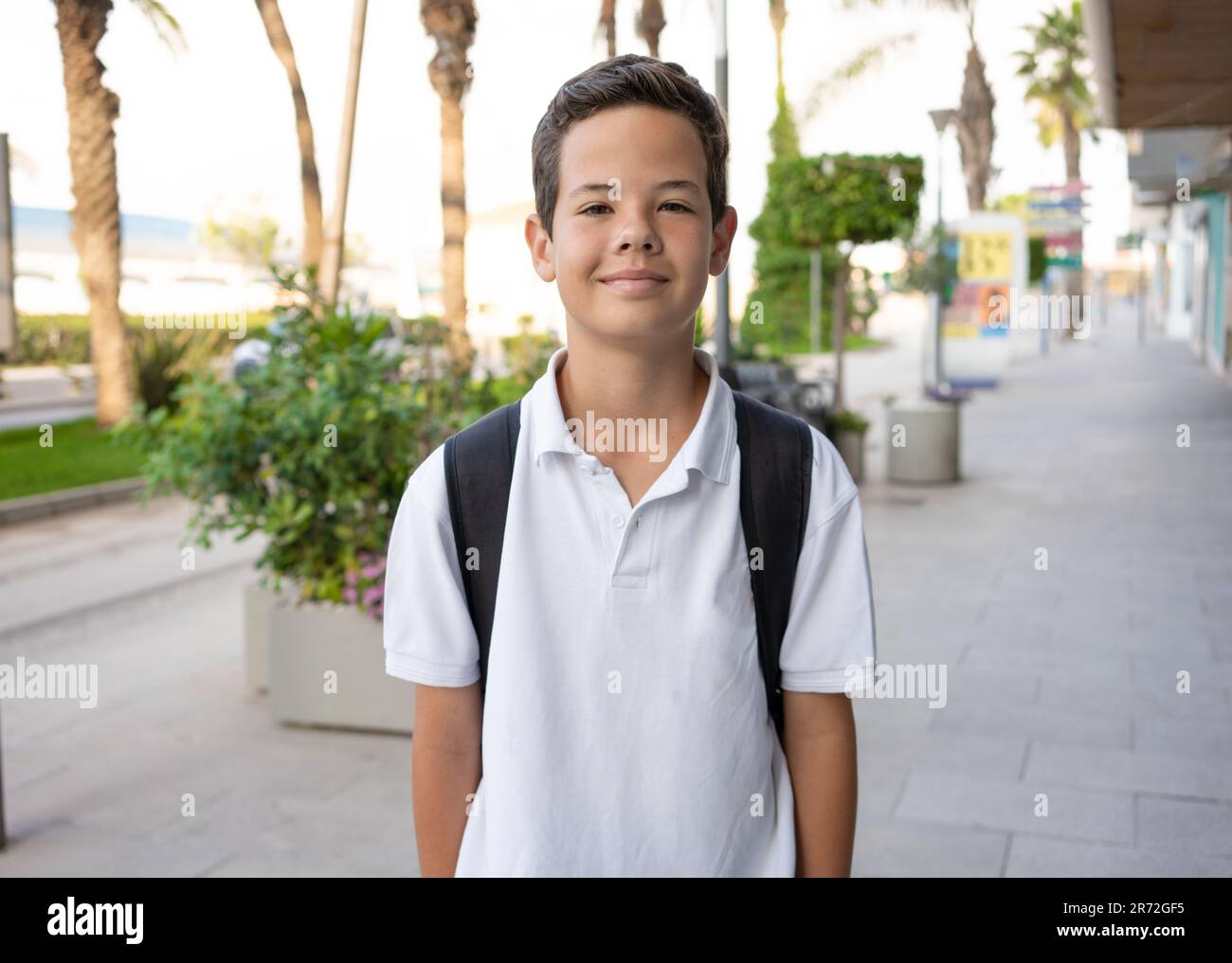 Charming caucasian teenager with backpack outdoors Stock Photo - Alamy
