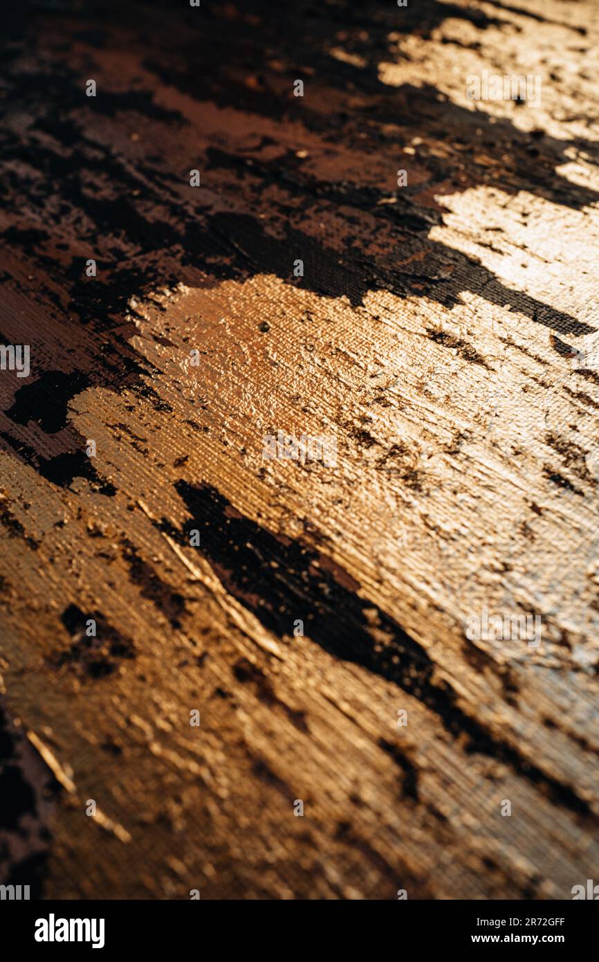 Abstract contemporary paint black oil strokes and glow golden shiny ...