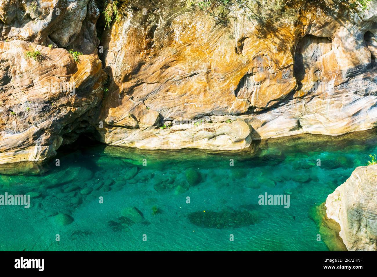 An idyllic scene of a small pool of pristine water nestled amongst a ...