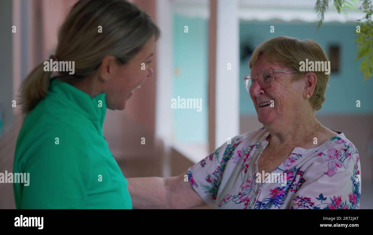 Warm family reunion, adult daughter embracing elderly mother ...