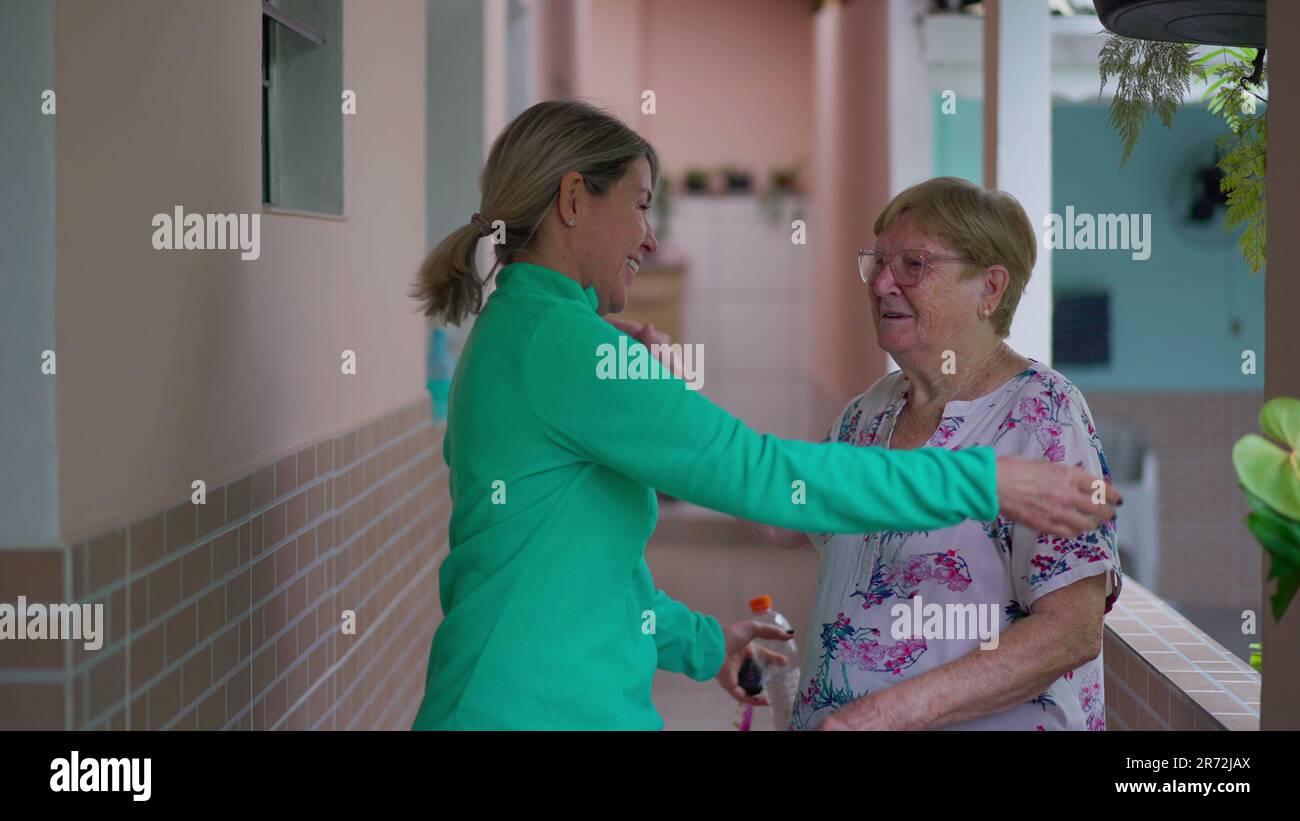 Warm family reunion, adult daughter embracing elderly mother ...