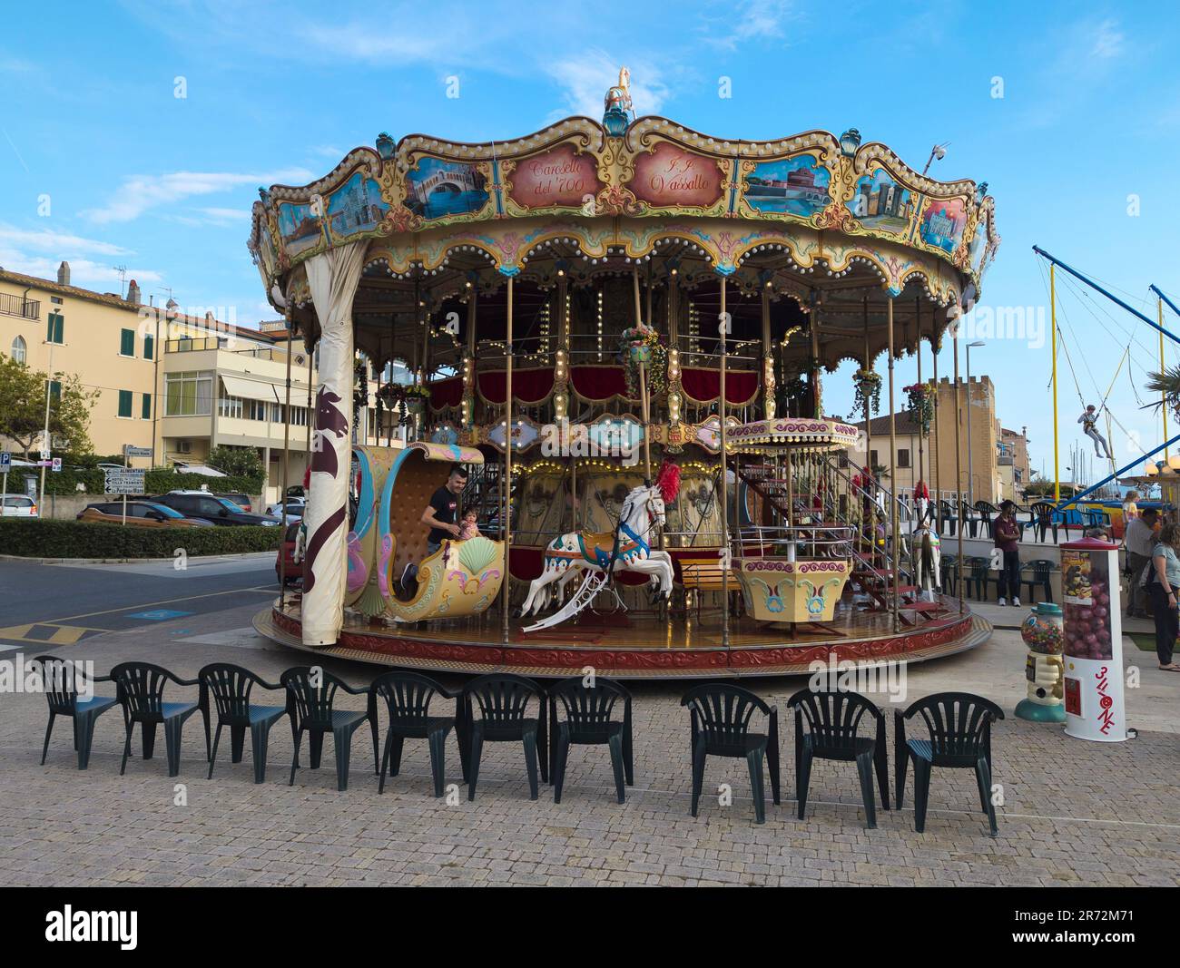 Vintage carousel in the central square of the village of San Vincenzo ...