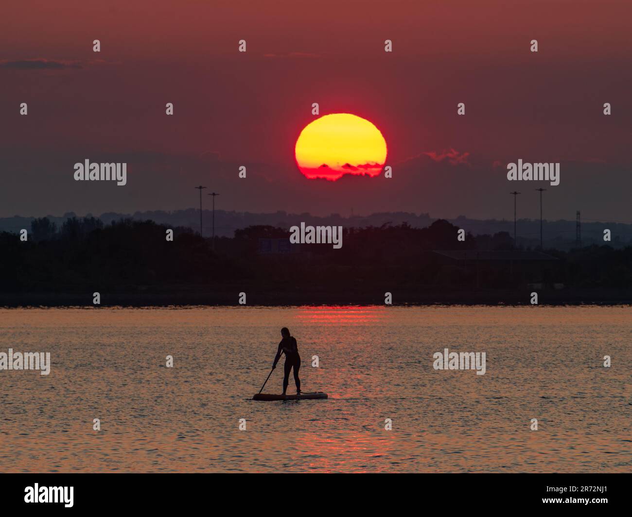Paddleboarder sunset silhouette at the Malahide Estuary Stock Photo - Alamy