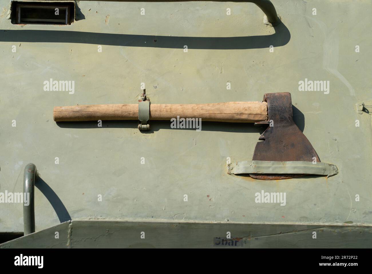 An axe attached to the side of an green armored vehicle Stock Photo - Alamy