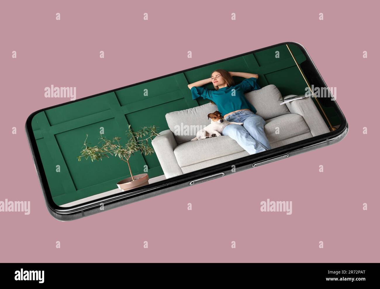 Photo of young woman with her dog on screen of modern mobile phone ...