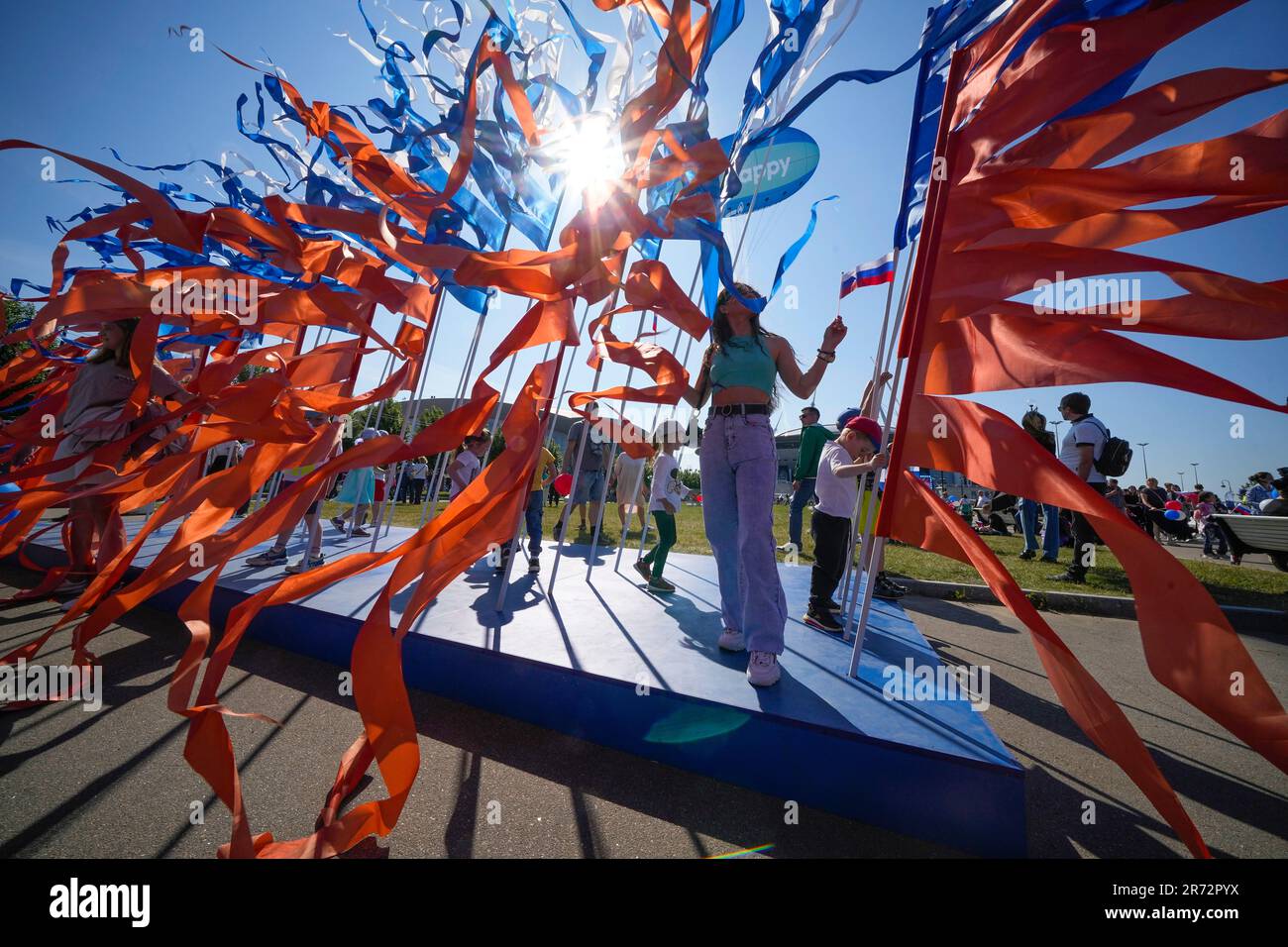 A woman poses for a photo during celebrations of the Day of Russia at a park in St. Petersburg ...