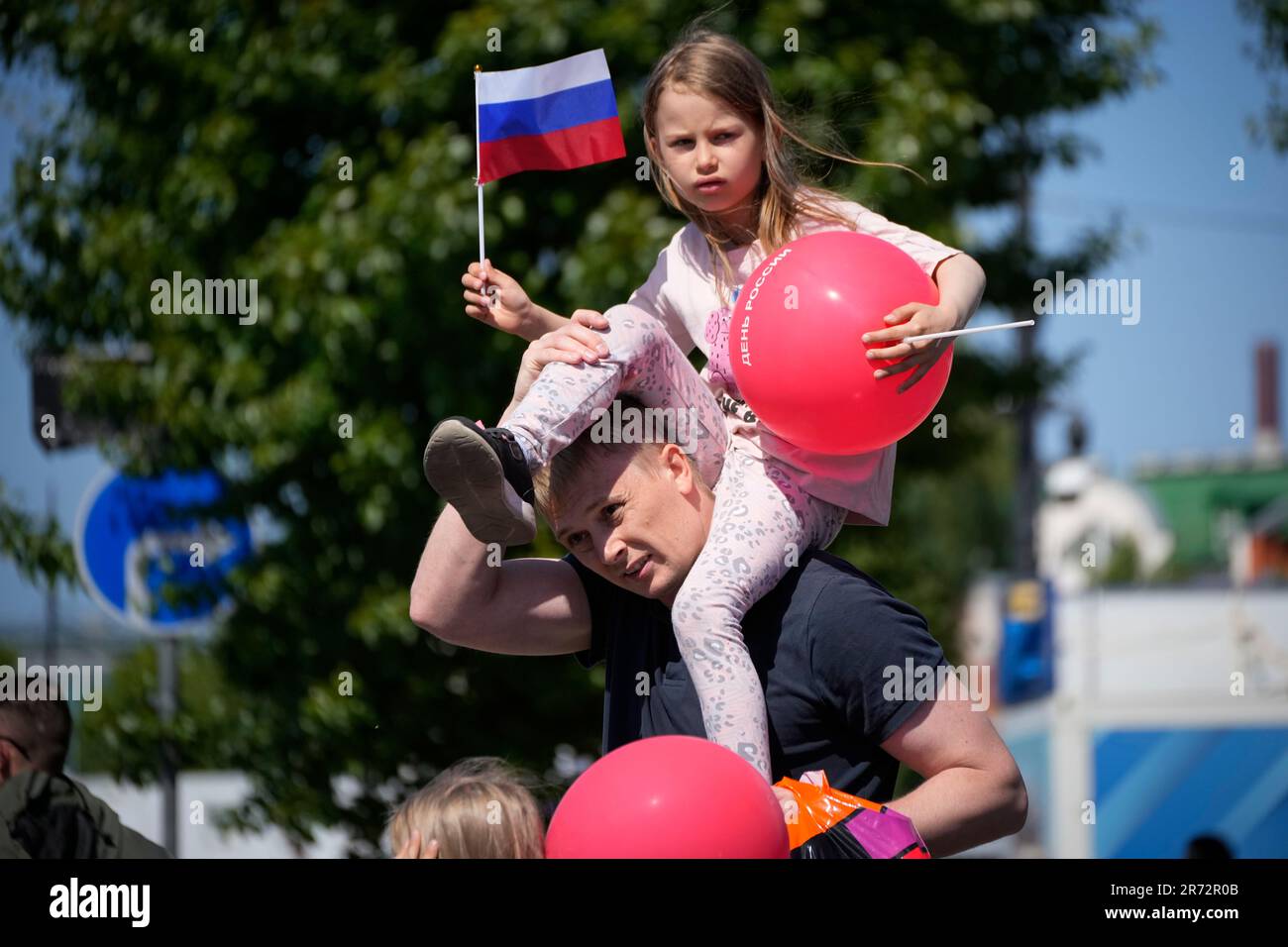 A man holds her daughter during celebrations of the Day of Russia at a ...