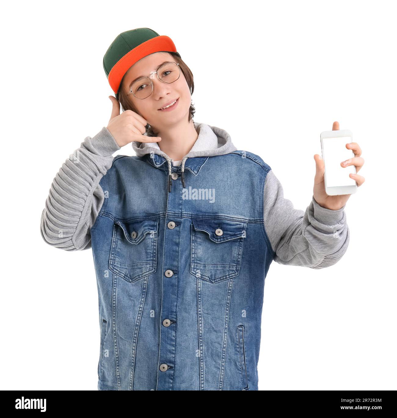 Cool teenage boy with mobile phone showing "call me" gesture on white ...