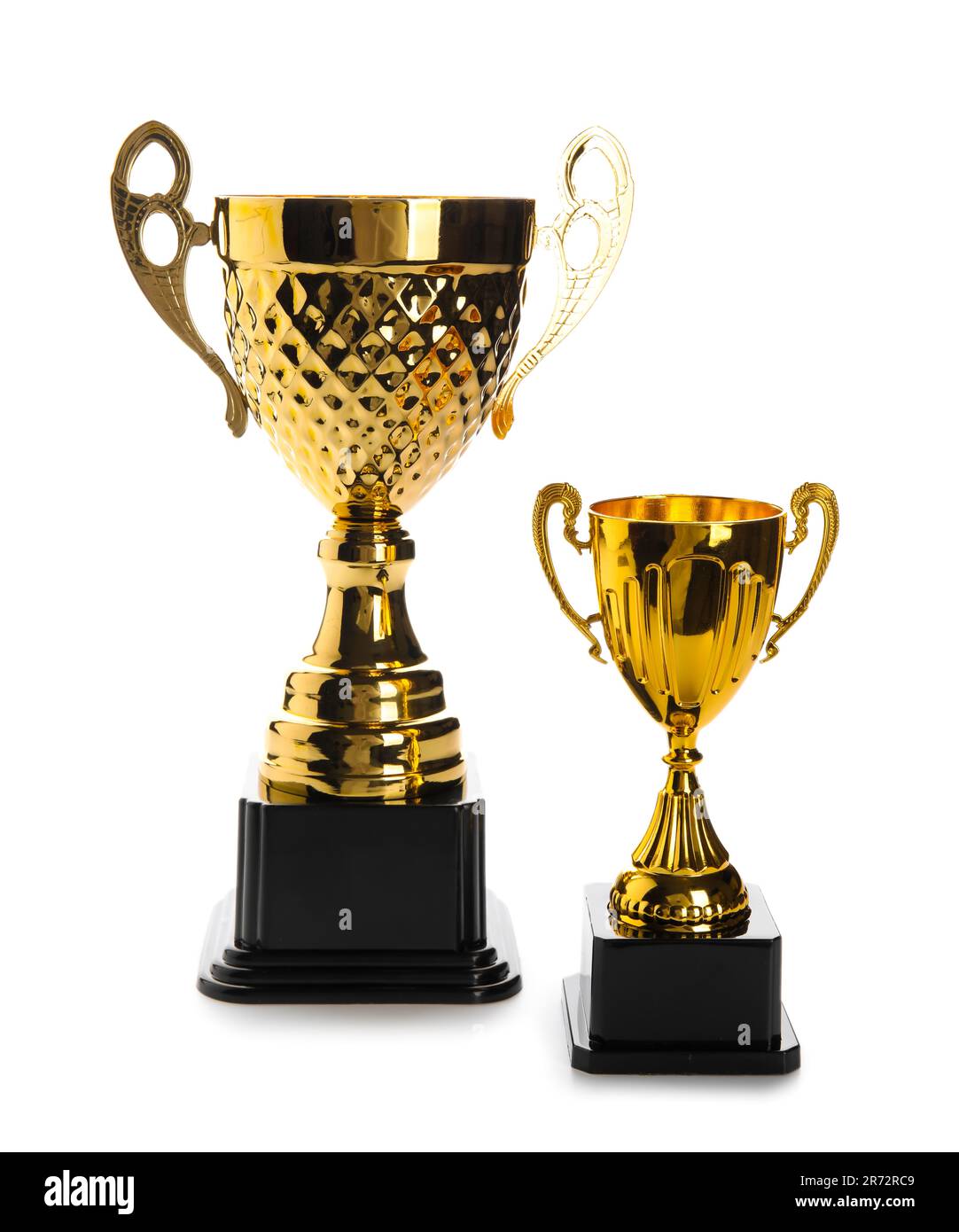 Gold cups on white background Stock Photo - Alamy