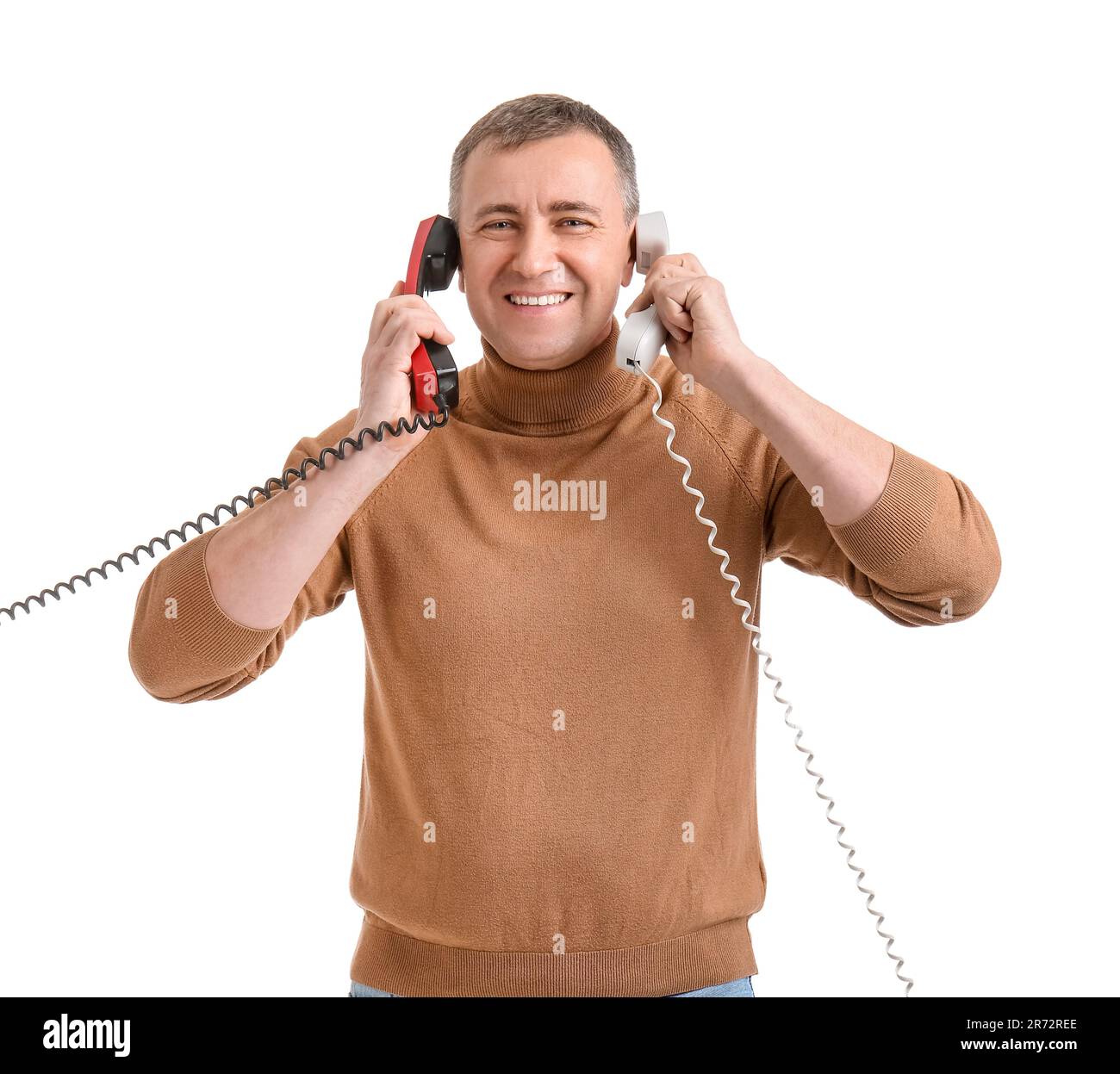 Mature man with phone receivers on white background Stock Photo - Alamy