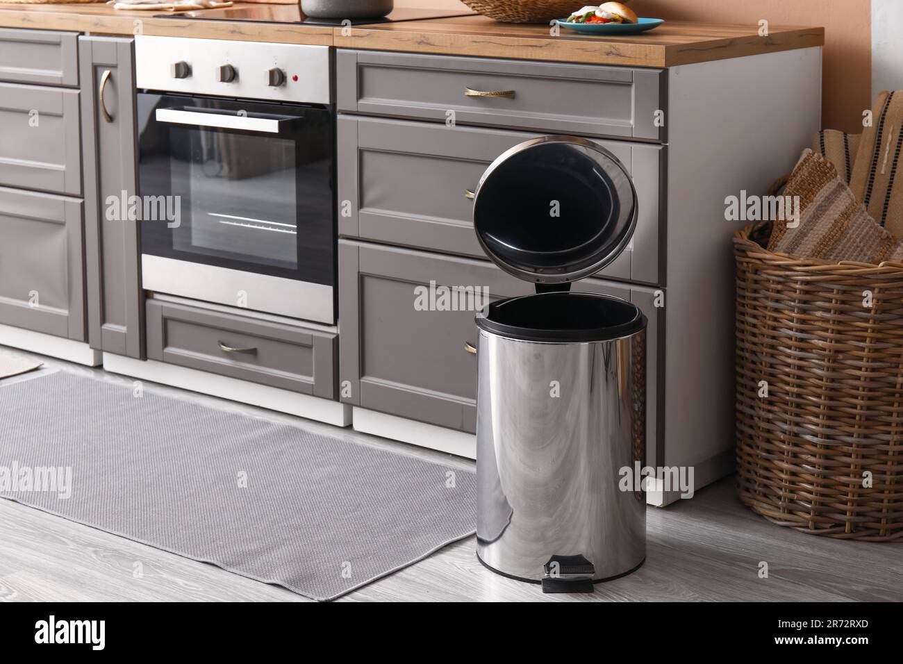 Opened metallic trash bin on floor in modern kitchen Stock Photo - Alamy