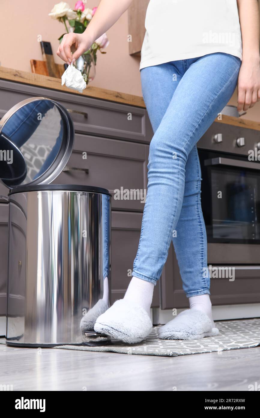 Woman throwing rubbish into trash been in modern kitchen Stock Photo ...