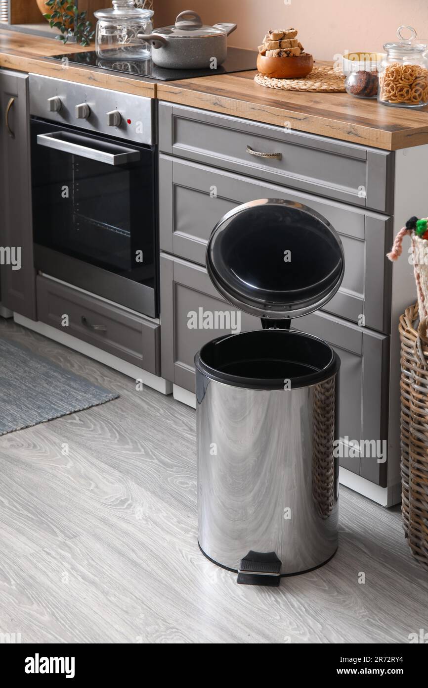 Opened metallic trash bin on floor in modern kitchen Stock Photo - Alamy