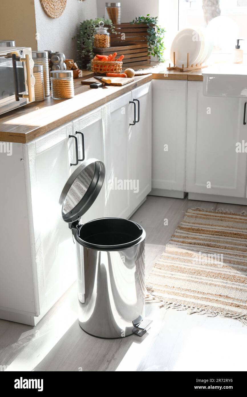 Opened metallic trash bin on floor in modern kitchen Stock Photo - Alamy
