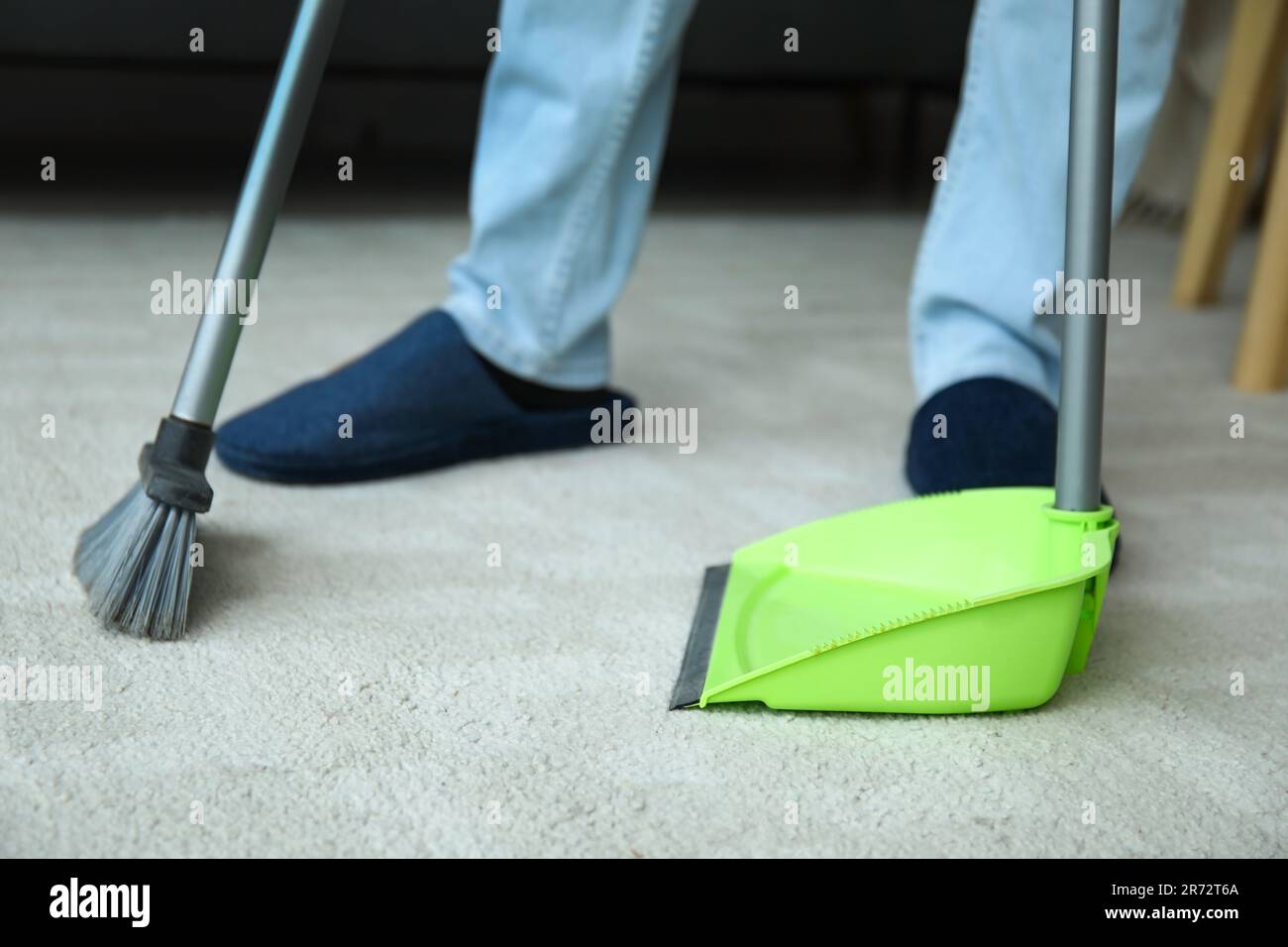 Man sweeping floor dustpan broom hi-res stock photography and images ...