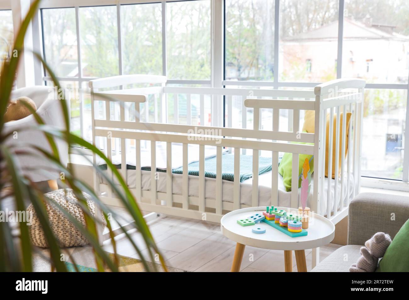 Stylish interior of children's room with baby bed and big windows Stock ...