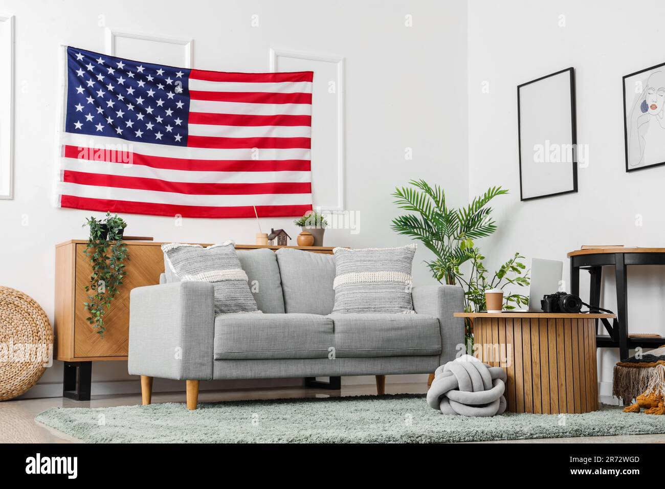 Interior of living room with hanging USA flag and sofa Stock Photo - Alamy