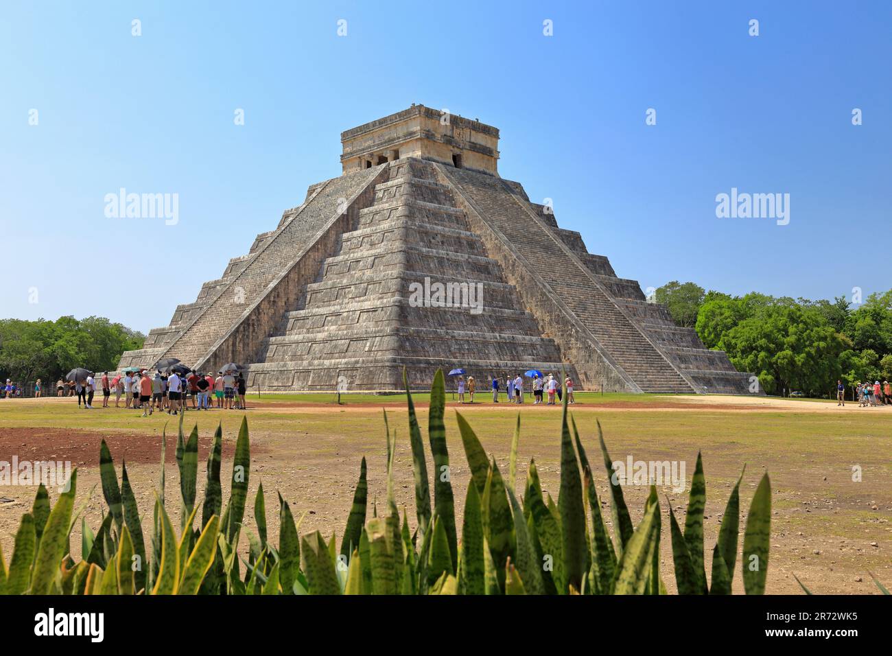 Tourists at the base of The Castle, El Castillo or Pyramid of Kukulcan ...