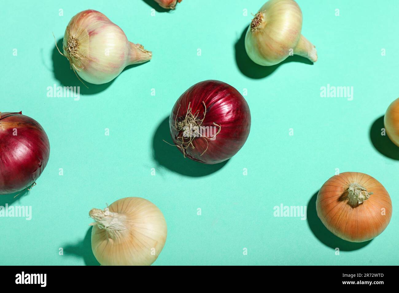 Different kinds of onion on turquoise background, closeup Stock Photo ...
