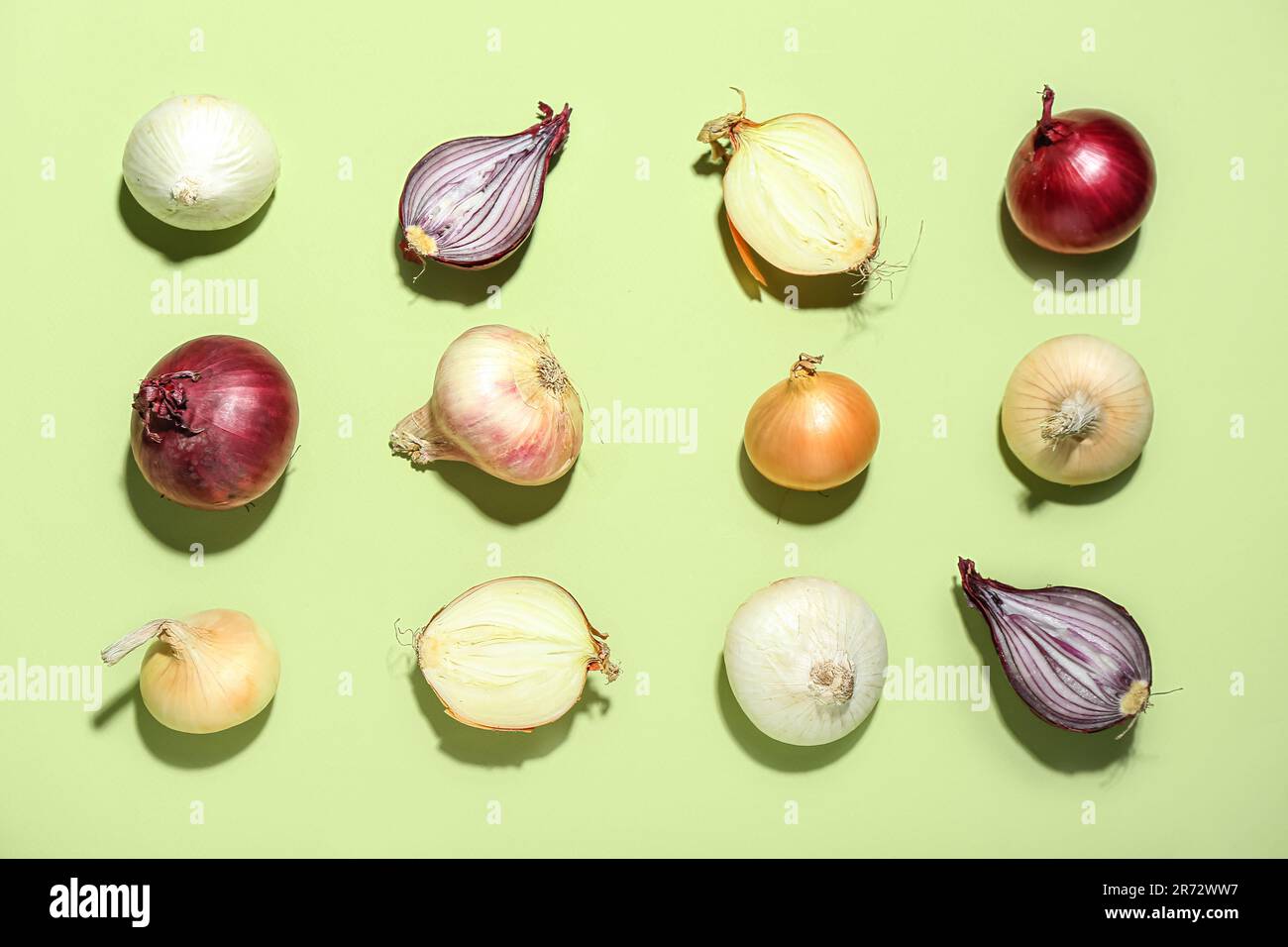 Different kinds of onion on green background Stock Photo - Alamy