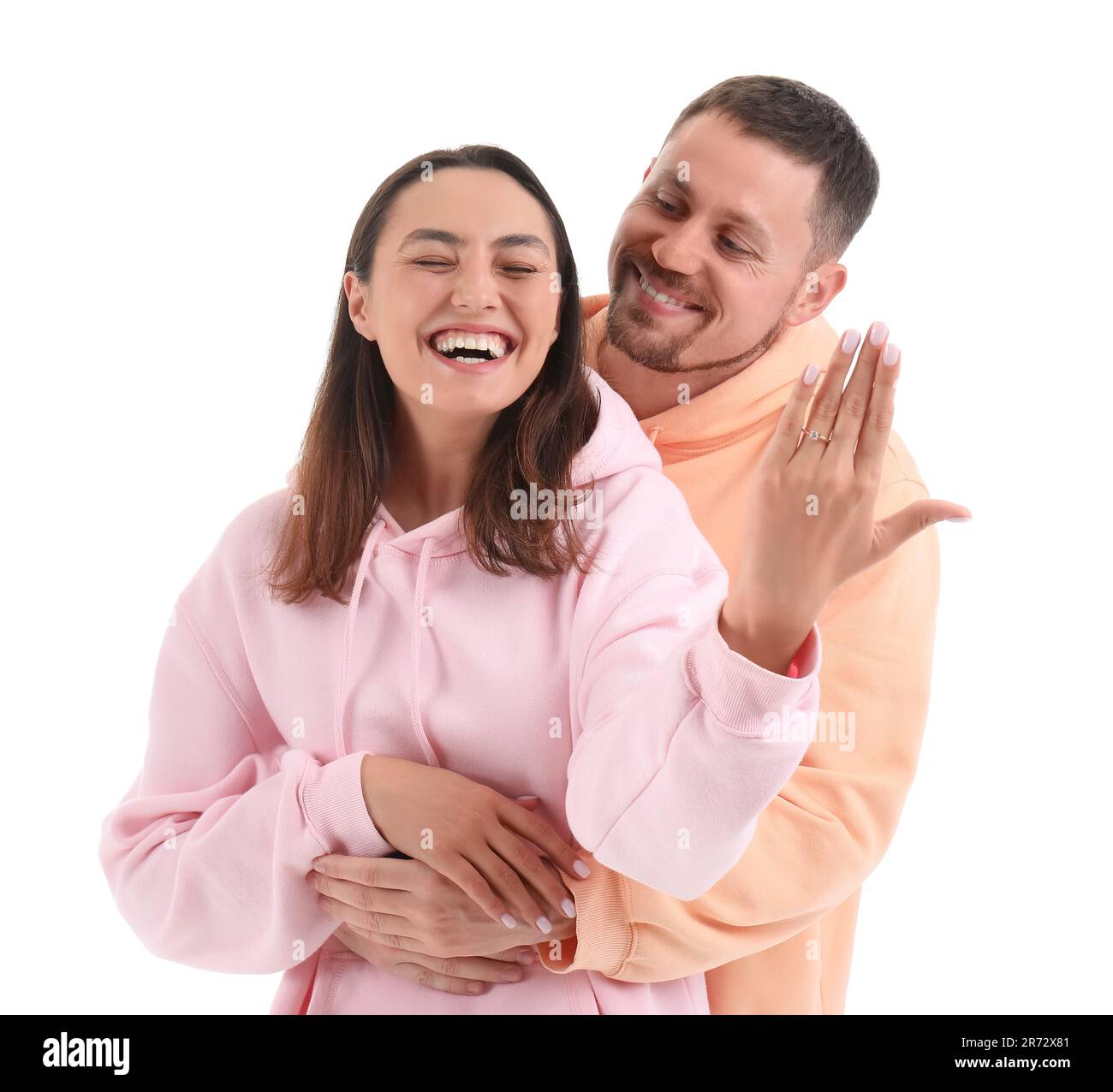 Happy engaged couple hugging on white background Stock Photo - Alamy