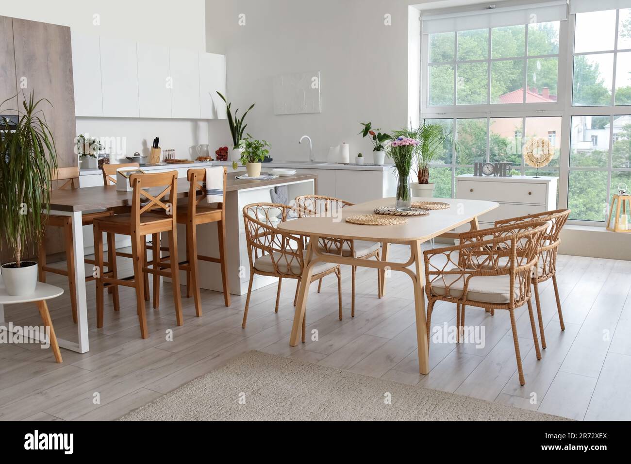 Interior of light open plan kitchen with dining table and island Stock ...