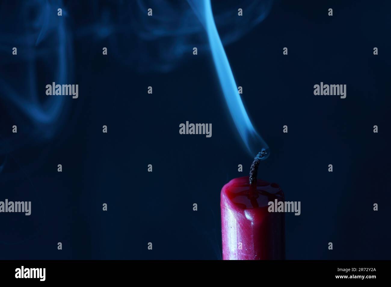 candle with smoke and flame photographed in the studio with color foils ...