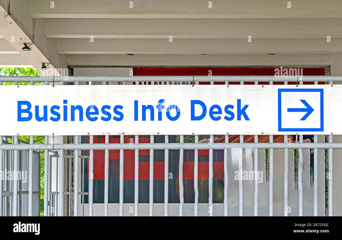 Business info desk sign with direction arrow outside on a building ...