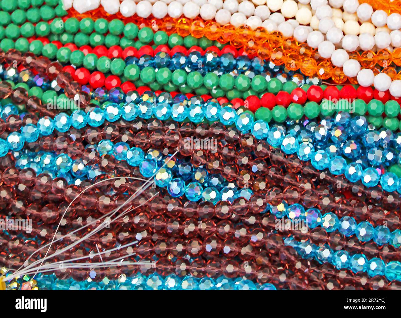 Large pile of colorful plastic and glass beads used as a craft tool for ...