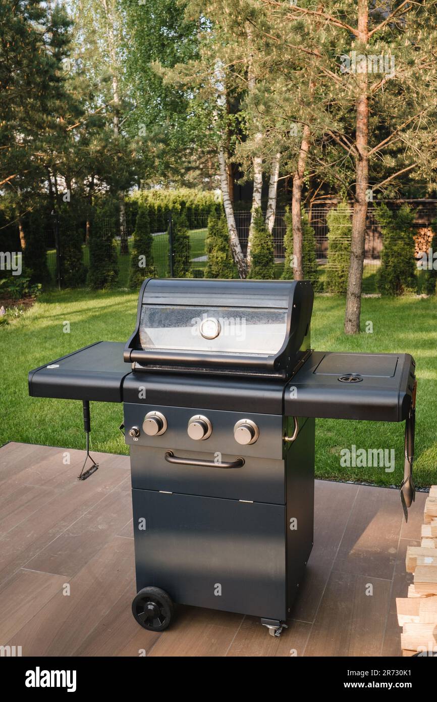 A large barbecue grill stands in the courtyard on the terrace street ...